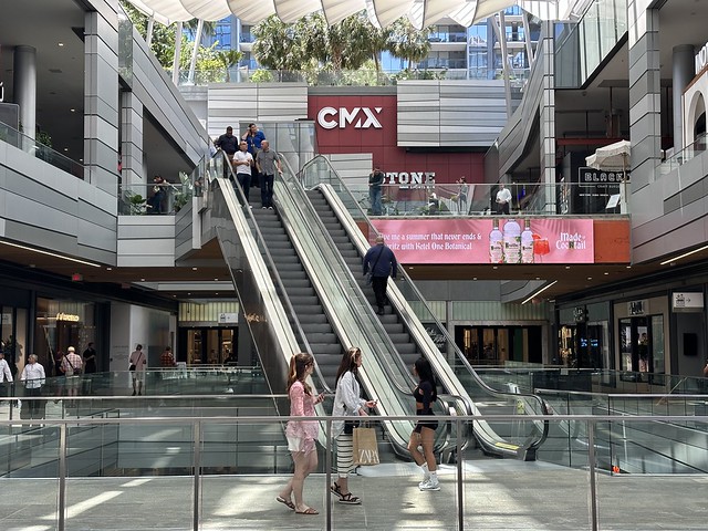 Brickell City Centre – CMX Theater Atrium: Sunlit multi-level escalators amid glass balconies and shoppers