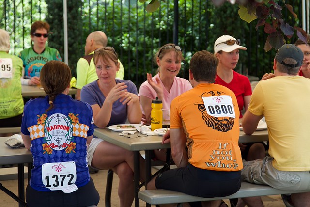 Rest Stop Portrait at a 32-Mile Cycling Event: Riders Gathering Around a Shaded Park Table
